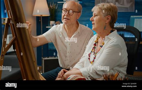 Senior People Doing Teamwork Drawing To Create Sketch Model On Canvas