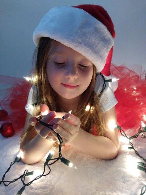 Close Up Of Girl Holding Illuminated String Lights Premium Photo