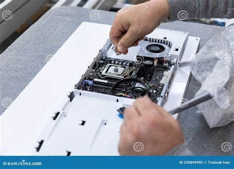 Photo Of Hands Of Man Who Assembles A Computer Monitor System Block On