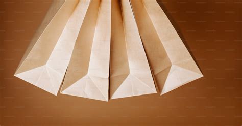 장갑이 달린 종이 봉지를 들고 있는 손 사진 Unsplash의 유행 이미지