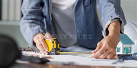 Civil Engineer Measuring Dimensions For Structural Accuracy In Building