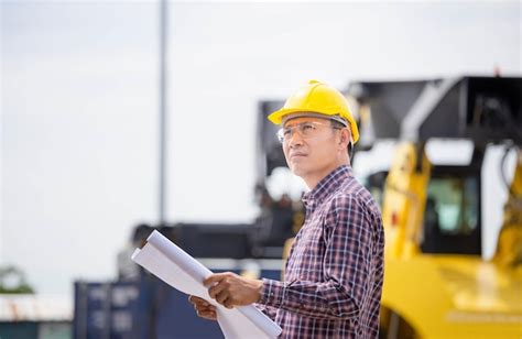 Premium Photo Engineer Man With Blueprint Checking And Inspect Container In Industry Cargo