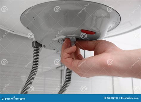 Woman Adjusting Maximum Energy Efficiency Indicator Indoors Closeup