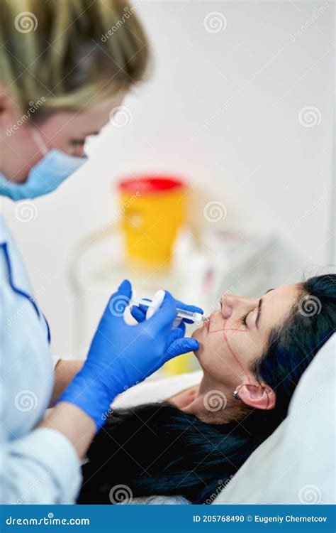 Close Up Of Hands Of Cosmetologist Making Botox Injection She Is Holding Syringe Woman Is