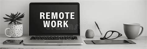 Remote Work Setup With Laptop Plant Coffee Mug And Glasses For A