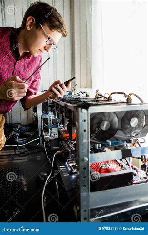 programmer configures hardware for bitcoin mining stock image image