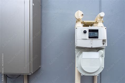 Gas Meter Propane Metering Device Electric Meter Near Gray Wall