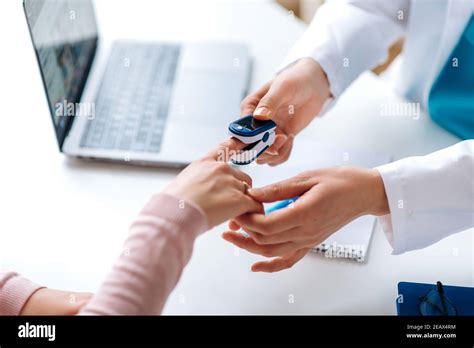 Close Up Photo Of Oxygen Pressure Measurement Female Hands Of A Doctor And Patient Doctor Uses