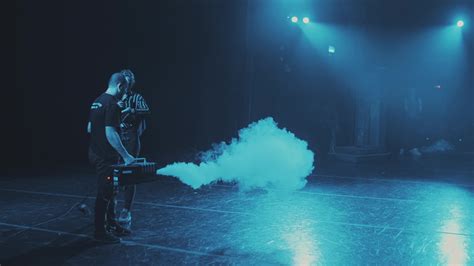 A Stage Worker Fills The Smoke Scenes From The Smoke Machine Preparation For A Concert Or