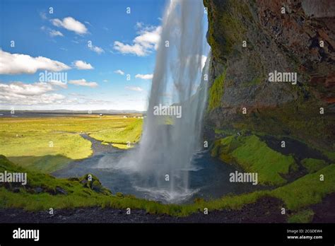 A View From The Side Of Seljalandsfoss Waterfall On A Bright Sunny Day