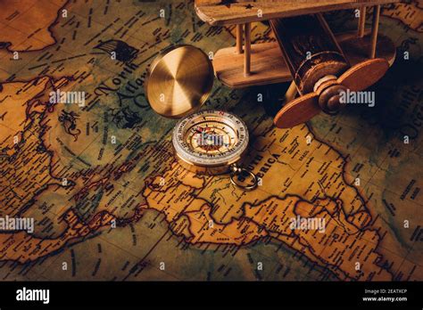 Old Compass Discovery And Wooden Plane On Vintage Paper Antique World