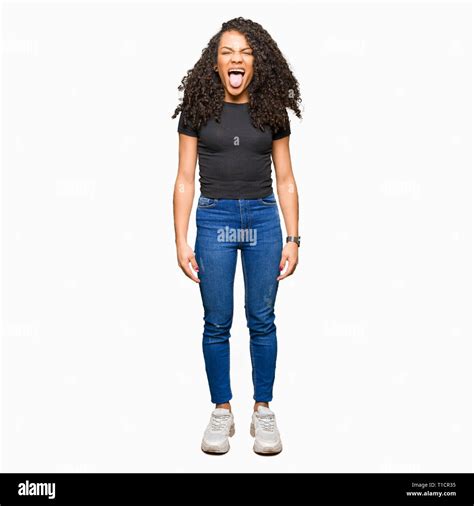 Young Beautiful Woman With Curly Hair Sticking Tongue Out Happy With