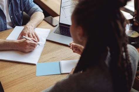Premium Photo Female And Male Hands On Table With Notebooks And Pens Taking Notes