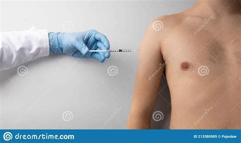 Hand With Syringe Injection And Topless Mans Torso Covid And Vaccination Concept Stock