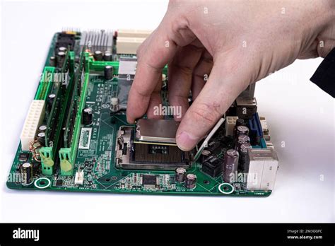 Engineer Repairman Holding Hands In Black Gloves Chip Processor CPU To Insert Into The Socket