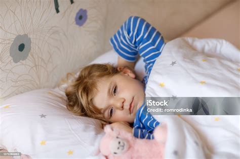 귀여운 어린 유아 소녀는 일어나 좋아하는 부드러운 봉제 인형 라마와 침대에서 자고 화가 슬픈 아기 아이 꿈 하루 동안 아이들의