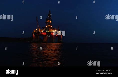 Drone Dolly In To Offshore Oil Drilling Rig At Night Moonlit Ocean Glow Stock Video Footage Alamy