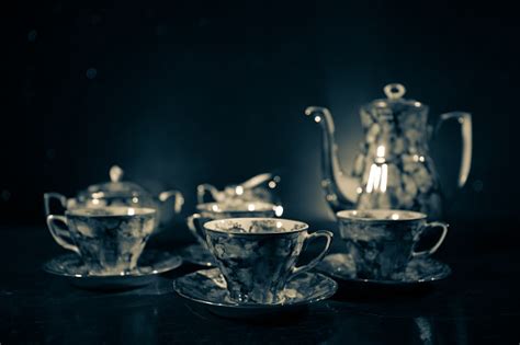 음식 배경 차와 커피 테마입니다 오래 된 빈티지 세라믹 차 또는 조명과 연기와 어두운 배경에 컵 용기와 설탕 컵 커피 포트 세라믹 차 주전자와 컵 실루엣 어두운 색에 대한