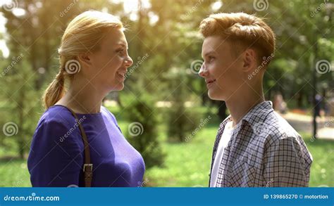 Caring Mother Looking At Her Teenage Son With Tenderness And Love
