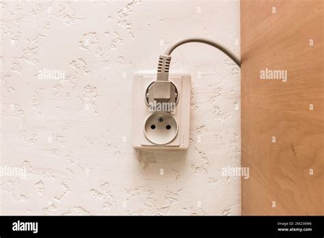 Two Plugs In The Socket In A Modern Interior Safe Connection Of Electrical Appliances Concept