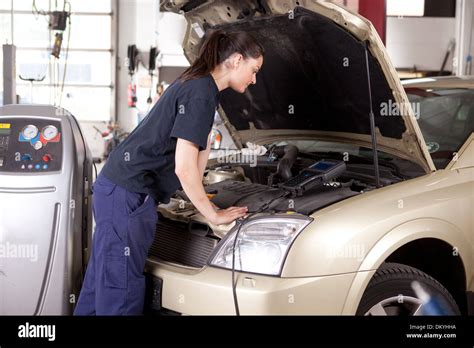 A Woman Mechanic Tuning A Car With Diagnostic Equipment Stock Photo Alamy