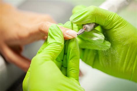 매니큐어입니다 그녀의 뷰티 살롱에서 일 하는 동안 그녀의 손에 파일을 들고 매니큐어의 숙련 된 마스터 고객에 대한 스톡 사진 및 기타 이미지 Istock