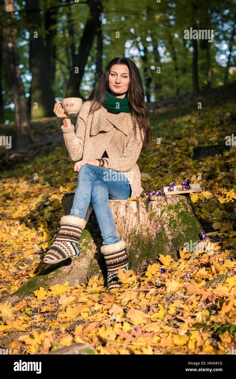 Girl Sitting On Tree Stump Stock Photo Alamy