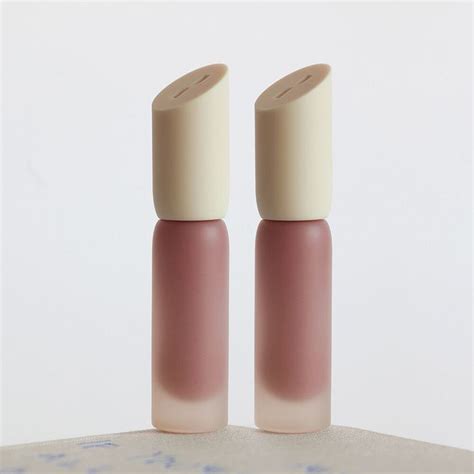 Two Pink And White Bottles Sitting Next To Each Other