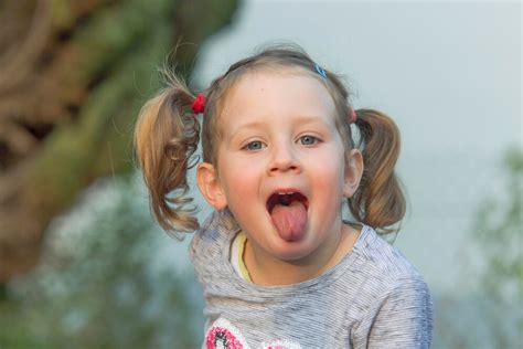 Premium Photo Portrait Of Cute Girl Sticking Out Tongue