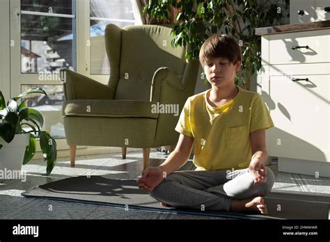 Little Boy Practicing Yoga Stretching Fitness At Home Distant Online