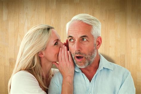 Premium Photo Woman Whispering A Secret To Husband Against Wooden Planks