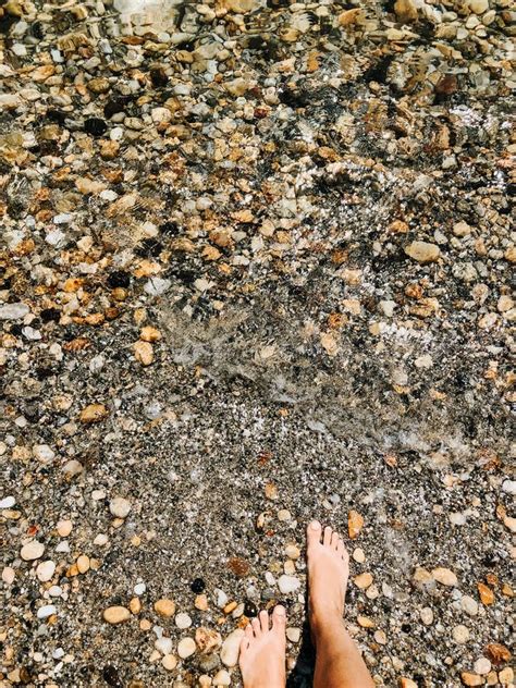 Woman Legs Barefoot At Sea Foam Waves On Sand Beach Summer Day Top