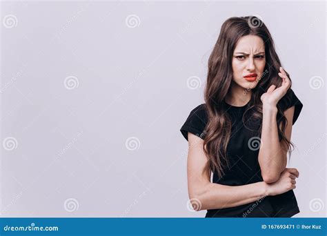 Displeased Cute Brunette Girl Showing Incomprehension And Disgust Stock