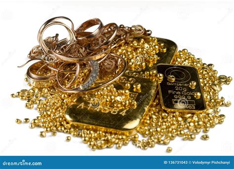 A Pile Of Gold Bars Gold Jewelry And Gold Granules Isolated On White