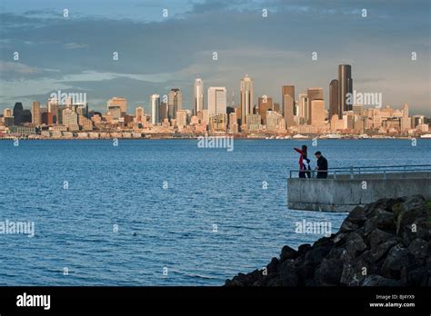 At An Alki Beach Park Visitors Enjoy The Sunset Over Elliott Bay And