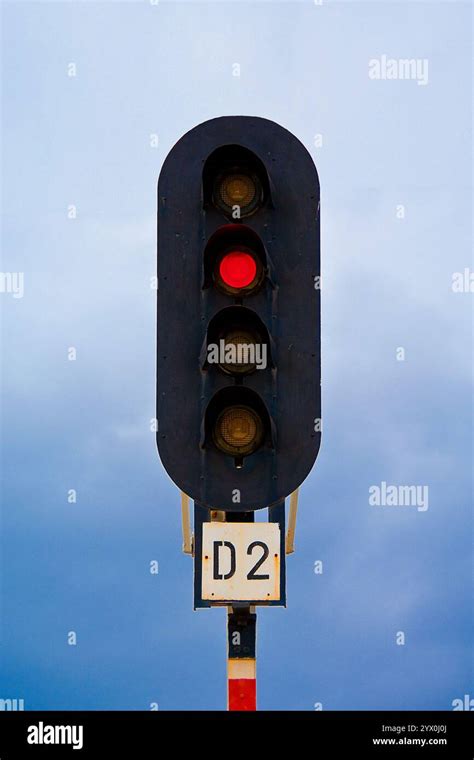 Semaphore Traffic Light On Train Station Shot Against Blue Clouded