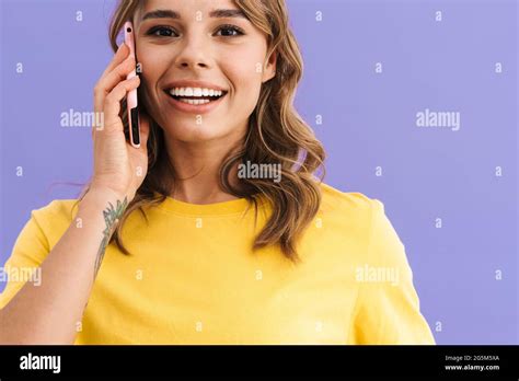 Happy Beautiful Girl Smiling While Talking On Mobile Phone Isolated