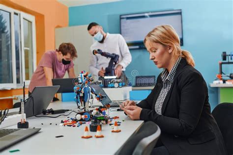 A Woman Sitting In A Laboratory And Solving Problems And Analyzing The