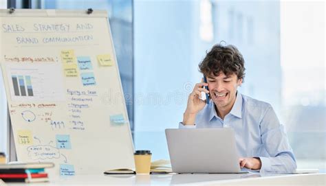 Businessman Phone Call And Statistics Charts In Office On Whiteboard On Laptop Financial Or