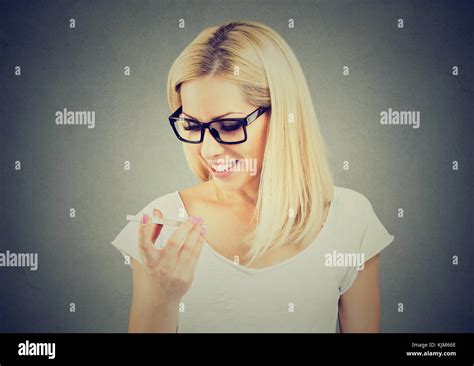 Woman Wearing Glasses Using A Smart Phone Voice Recognition Function