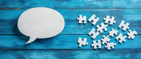 A Speech Bubble Floating Amidst Puzzle Pieces Against A Blue Backdrop Representing