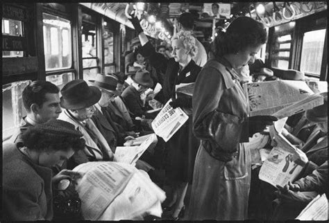 People Reading Newspaper On Train
