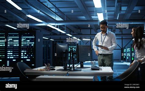 Admin In Data Center Working With Colleague To Maintaining Accurate Documentation Of Equipment