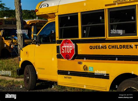 Yellow School Bus Against Blue Sky Stop Sign On A Side School Bus
