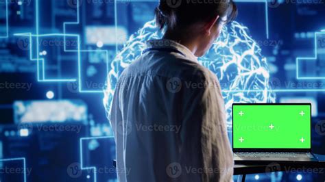 developer using green screen laptop to implement artificial