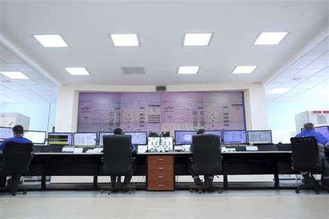 Operators Of The Control Panel Of Gas Station Sit At Large Monitors And