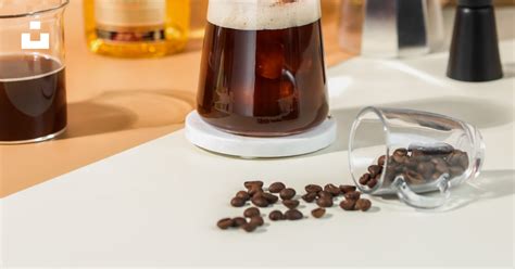 테이블에 액체 한 잔과 알코올 한 병 사진 Unsplash의 무료 커피 이미지