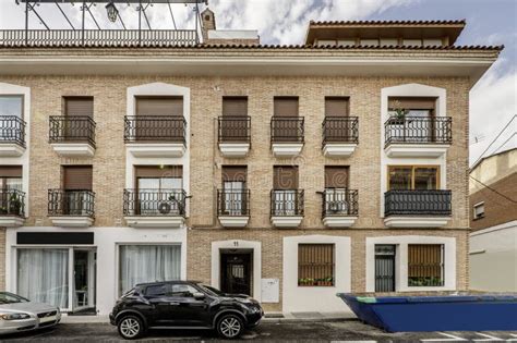 Facade Of A Low Rise Residential Apartment Building With Vehicles