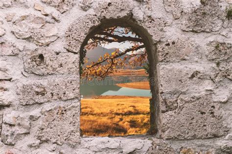 Scenic View Of A Tranquil Lake Seen Through A Stone Arch Window Stock Image Image Of Lake