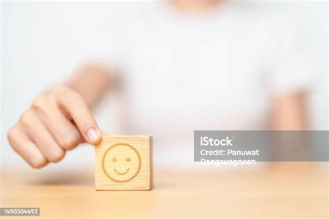 고객 리뷰 좋은 경험 긍정적인 피드백 만족도 설문 조사 평가 평가 기분 및 세계 정신 건강의 날 개념을 위해 감정 블록에서 행복한 얼굴을 선택하는 손 Mental